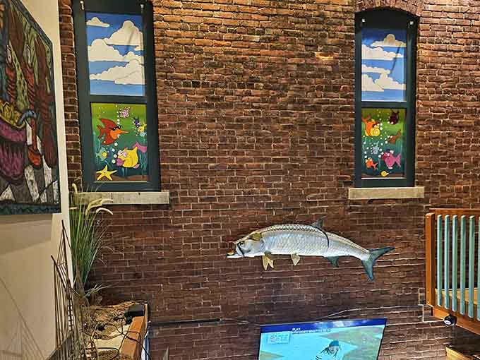Colorful fish art on exposed brick adds whimsy without crossing into tacky tourist trap territory we all dread.