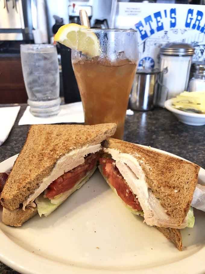 Turkey club stacked higher than your weekend plans, served with iced tea that actually tastes like tea.