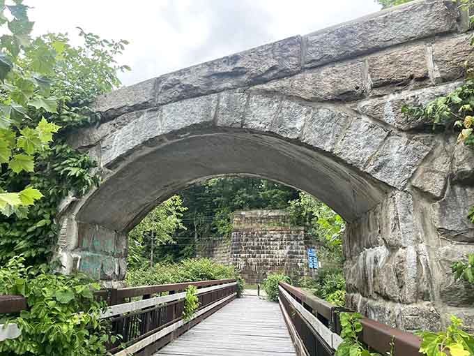 Stone archways and summer greenery create the kind of scene that makes your camera roll actually worth scrolling through.