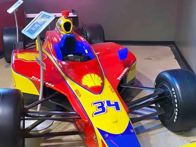 This vintage IndyCar on display reminds you that racing dreams come in all sizes, including the electric kart you're about to drive.
