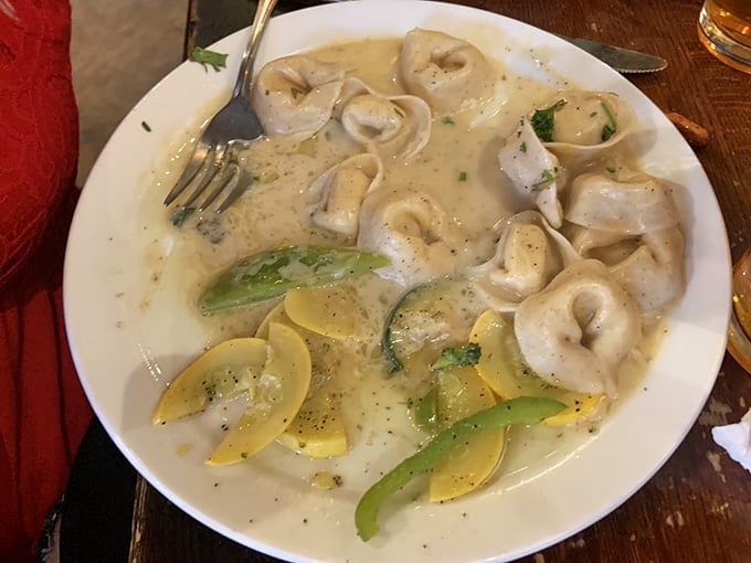Creamy tortellini with fresh vegetables swimming in sauce that looks like it was made by someone who actually cares about pasta.