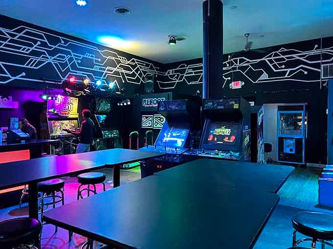 Geometric wall designs frame gaming stations and tables where strangers become friends over shared high score attempts.