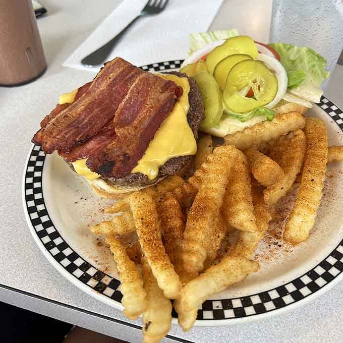 That bacon cheeseburger with seasoned fries is what happens when classic American comfort food reaches its full potential.
