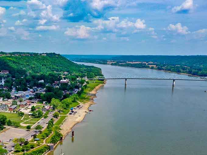 From above, the Ohio River curves through green hills like nature's own highway built long before interstates existed.