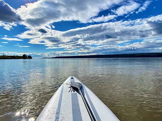 Paddleboarding on calm river waters where you won't get knocked over by waves&mdash;finally, water sports without the drama.
