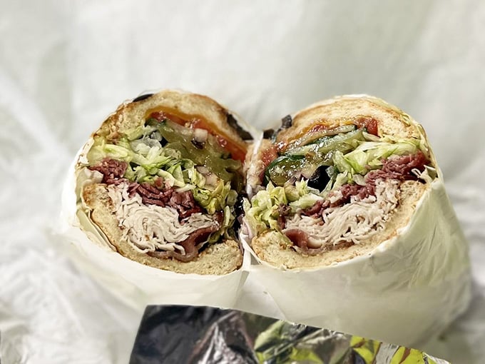 Perfectly layered meats and veggies creating a symphony of textures that holds together like architectural genius.