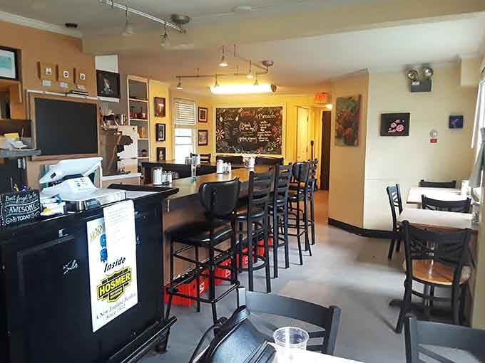 The cozy counter seating and eclectic wall art create an atmosphere where strangers become friends over coffee refills.