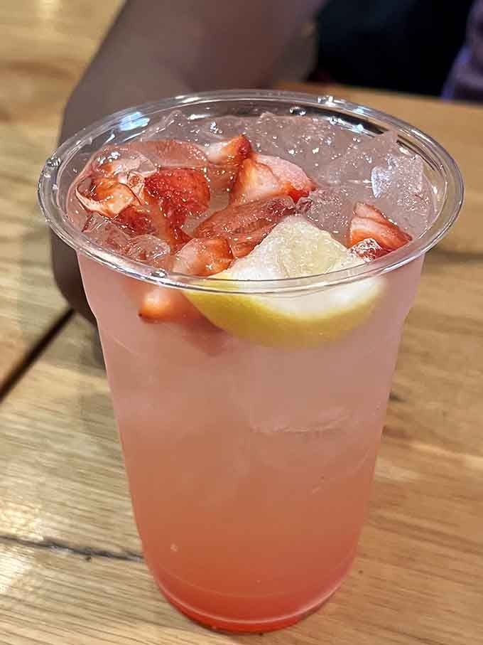 Strawberry lemonade loaded with fresh fruit chunks, because even your beverage should be an experience worth photographing and savoring slowly.