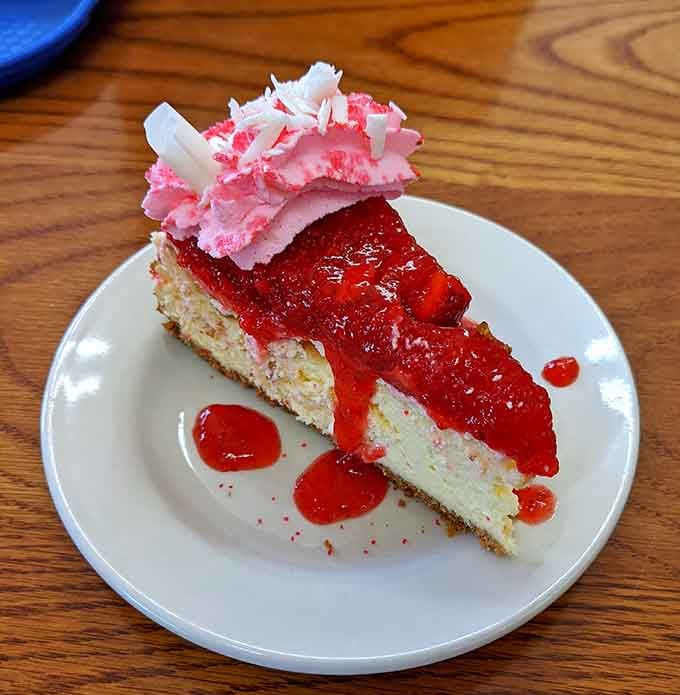 Strawberry cheesecake topped with whipped cream and fruit proves simple ingredients can create spectacular results when done right.