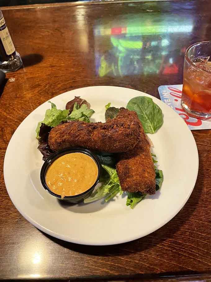 Golden-fried crab rolls with remoulade prove that sometimes the best seafood happens hundreds of miles from any coastline.