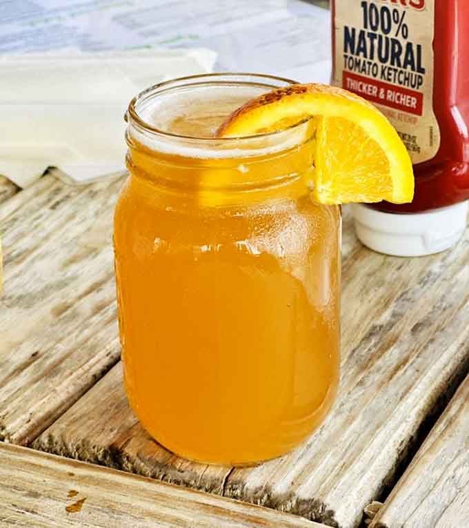 Sweet tea in a mason jar with an orange slice, because some Southern traditions simply cannot be improved upon.