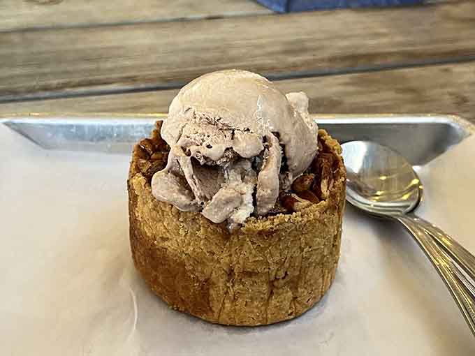 Ice cream nestled in what appears to be a pecan pie vessel, because apparently we're living in the best timeline.