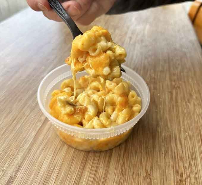 Mac and cheese with that cheese pull that makes you want to tag everyone you know in the photo.