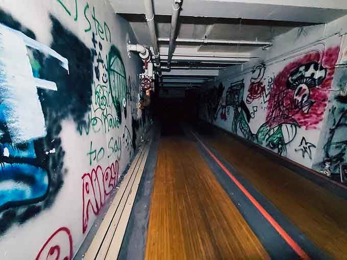 A basement bowling alley covered in graffiti proves that even abandoned asylums had recreational facilities back in the day.