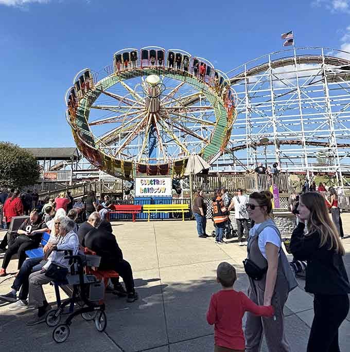 The Electric Rainbow draws crowds on a beautiful day, its vibrant colors matching the excitement in the air.