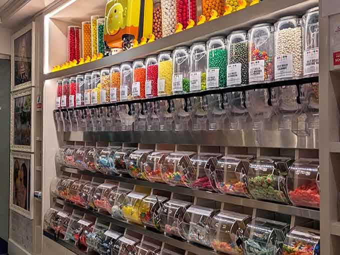 Wall-mounted candy dispensers organized by color create a rainbow that would make any leprechaun jealous of your snacking options.