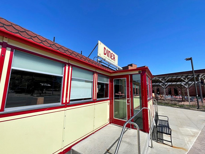 The vintage diner exterior against a blue sky looks like it jumped straight out of a 1950s postcard.