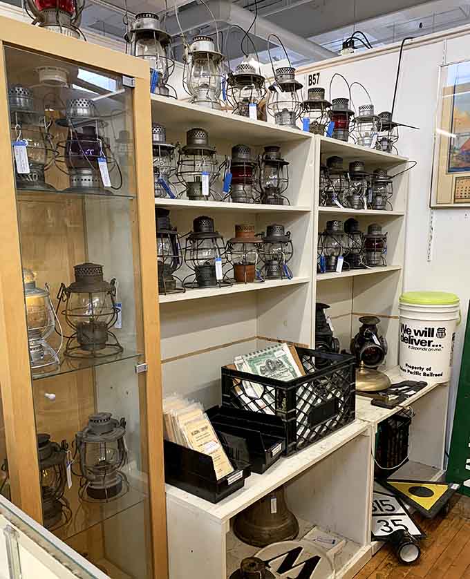 Railroad lanterns that once guided trains through darkness now illuminate the path to your perfect vintage find.