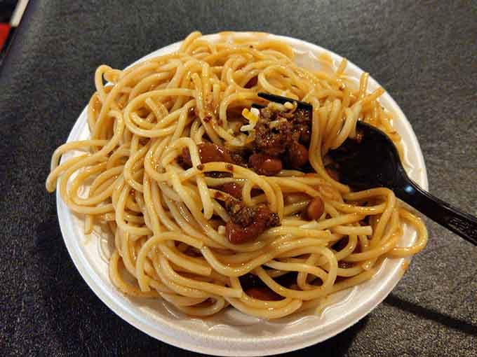 Spaghetti swimming in chili sauce represents the beautiful chaos that happens when two comfort foods collide perfectly.