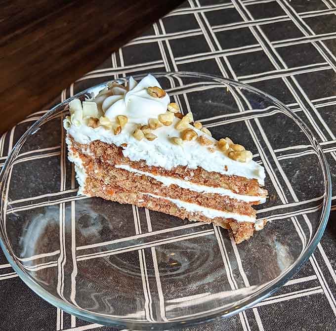 Carrot cake layered with cream cheese frosting and walnuts whispers sweet nothings to your dessert-loving soul with authority.