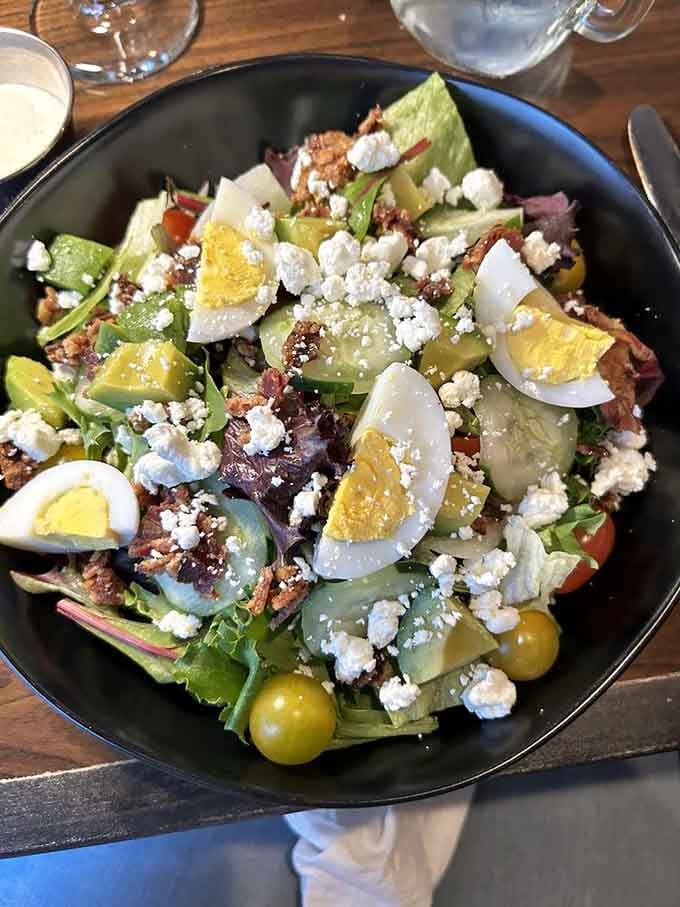 The Cobb salad arrives looking like a garden party decided to get serious about flavor.