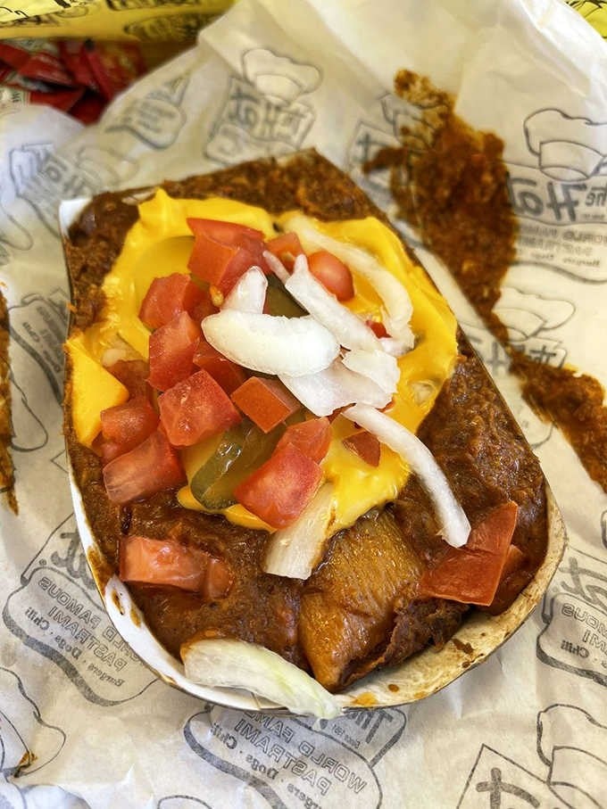 The chili tamale sits proudly in its boat, a hearty comfort food champion ready for action.