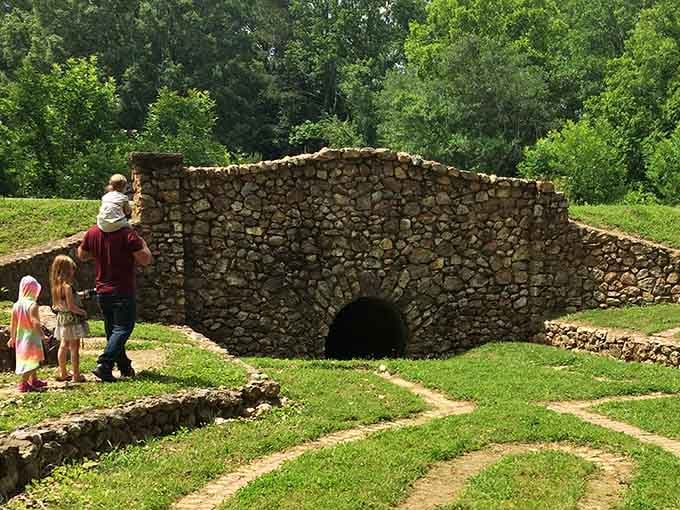 A family explores the stone grotto together, because the best adventures are the ones you share with people you love.