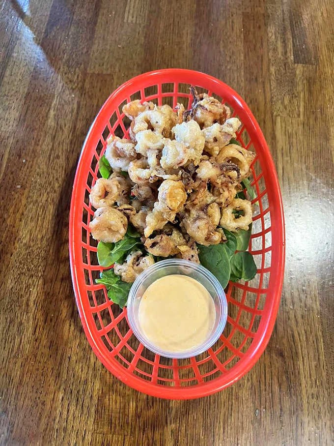 Crispy calamari rings in their red basket, proving squid never looked so good this far from any coastline.