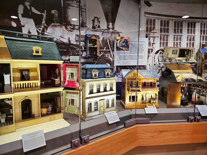 Row after row of miniature houses line the gallery like a neighborhood designed by very talented elves.