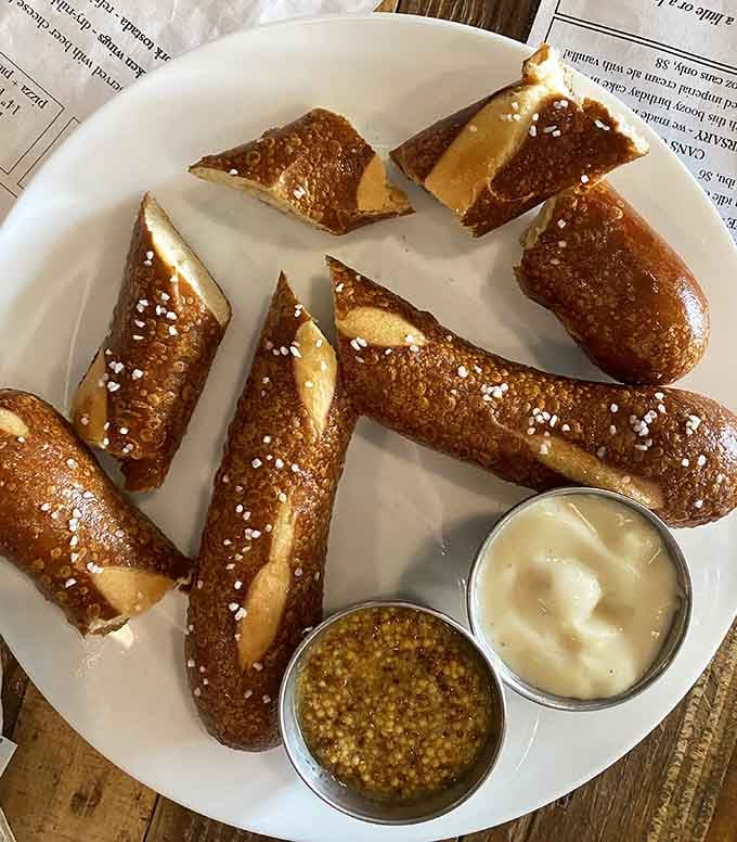 Soft pretzels with that perfect golden crust and salt crystals sparkling like tiny flavor diamonds—carbs never looked so absolutely gorgeous and tempting.