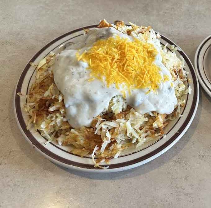 These stuffed hash browns topped with gravy and cheese redefine what potatoes can achieve with proper ambition.
