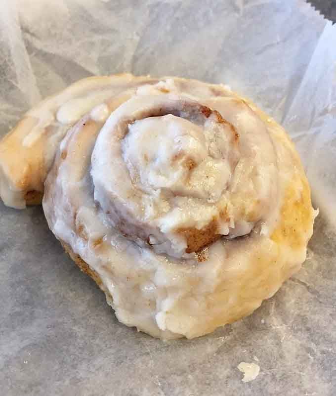 A cinnamon roll this generously glazed should probably come with a warning label and a happiness guarantee.