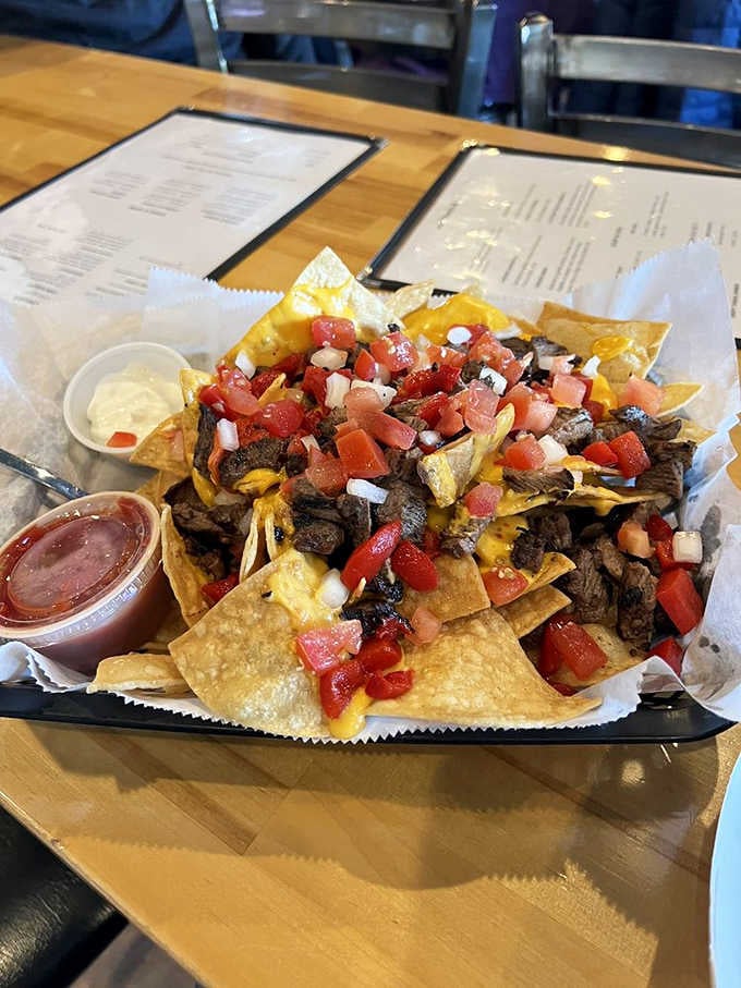 Loaded nachos piled high with all the fixings, because sometimes you need to start strong before the chicken arrives.