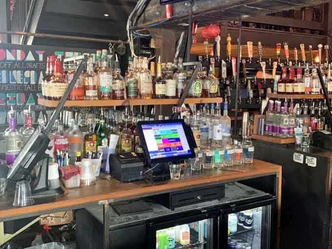 A well-stocked bar where the hardest decision is choosing between craft beer and classic cocktails while gaming.
