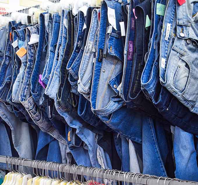 Denim dreams hang in perfect formation, waiting to become someone's new favorite pair of jeans.