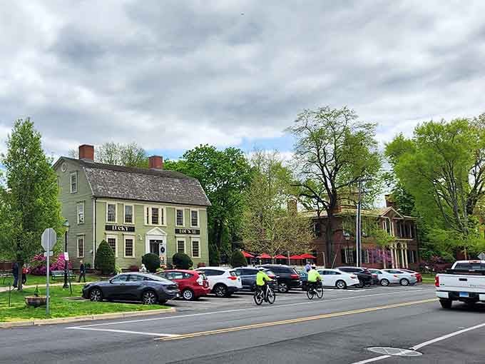 Spring blooms frame historic homes where people actually live, proving time travel is possible with the right real estate.