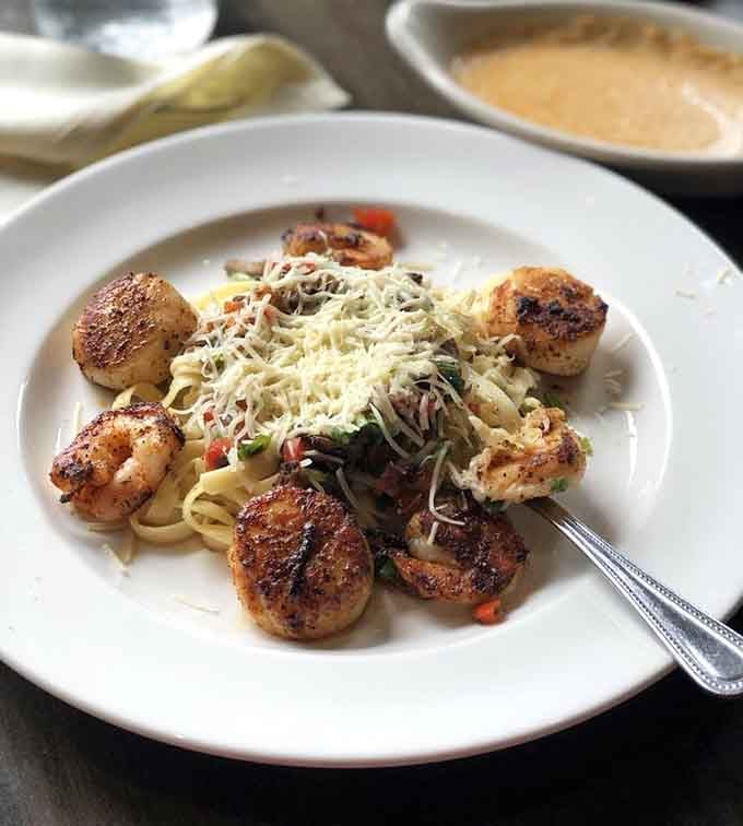 Seared scallops and shrimp over pasta, because sometimes you need to remind yourself you're eating better than most coastal restaurants.