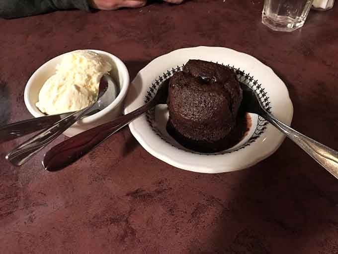 Rich chocolate cake with vanilla ice cream proves that some dessert combinations achieve timeless perfection without trying.