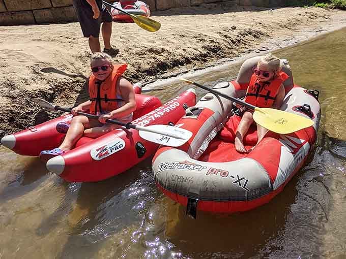 Kids discovering that the best waterpark doesn't need slides when you've got an actual flowing river.