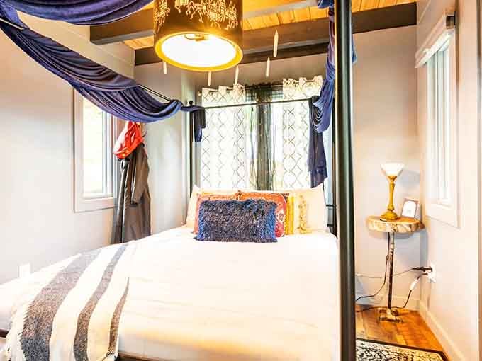 Draped fabric overhead transforms this bedroom into something straight from a Hogwarts dormitory fantasy come alive.