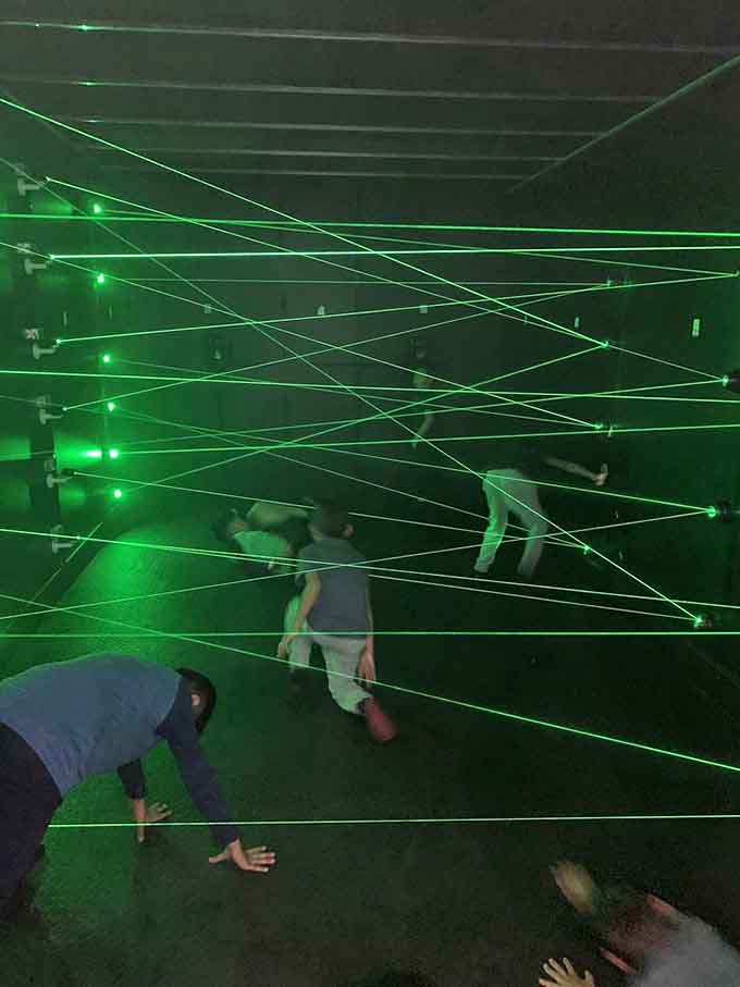 Green laser beams crisscross like a spy movie set, turning kids into secret agents on impossible missions.