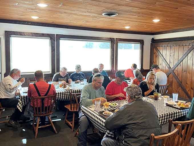 Happy diners enjoying hearty meals at checkered tables. This is what community and comfort food look like together.