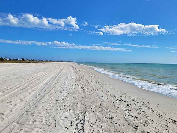 Miles of powdery white sand stretch endlessly along calm Gulf waters under picture-perfect blue skies.