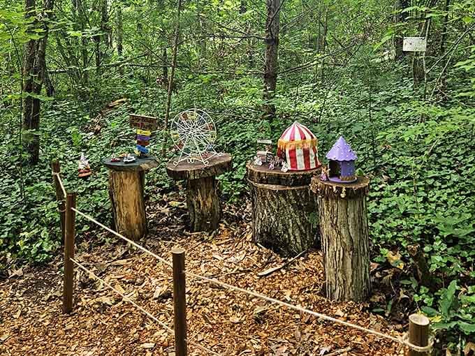 A tiny circus tent and Ferris wheel perch whimsically on tree stumps in this enchanting fairy village display.