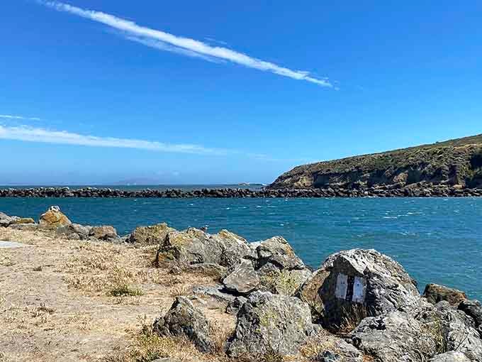 Rocky outcrops guard the harbor entrance while calm waters invite kayakers to explore this coastal gem.