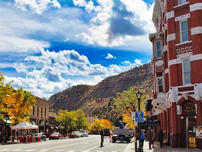 Golden aspens frame brick buildings in a fall display that makes every street corner Instagram-worthy gold.