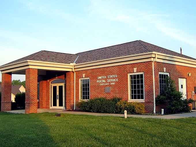 The post office building glows in evening light, its clean brick lines and welcoming entrance embodying small-town accessibility.