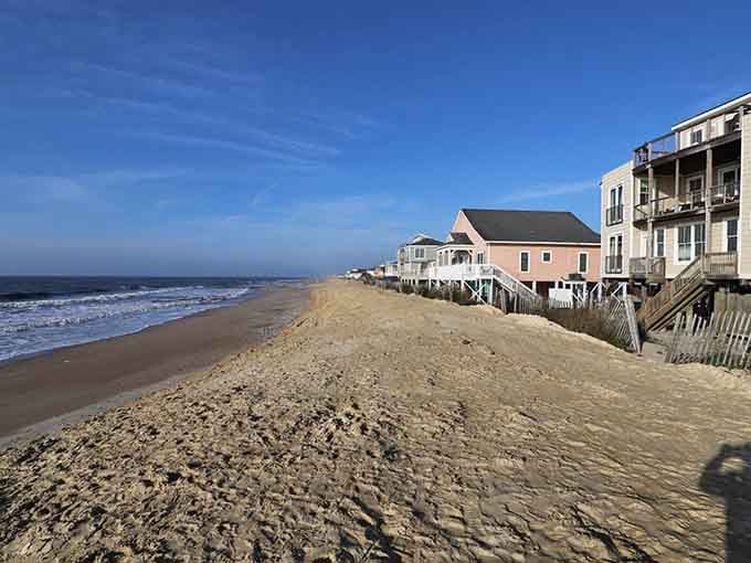 Colorful beach houses on stilts line the shore like a postcard from a simpler, quieter time.