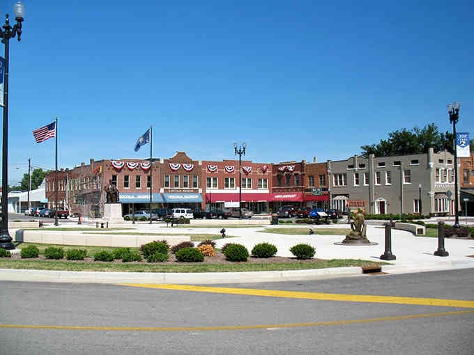 Patriotic bunting decorates the town square where red brick storefronts have welcomed shoppers for generations without changing much.