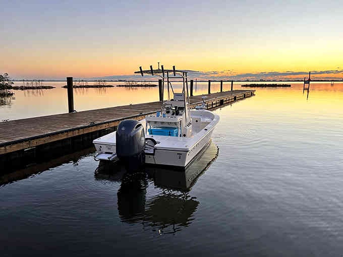 Golden hour paints the lagoon in sherbet colors while a fishing boat waits patiently for tomorrow's adventure to begin.